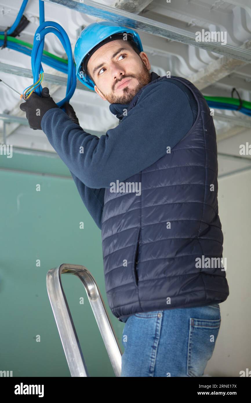 Male electrician on stepladder hi-res stock photography and images - Alamy