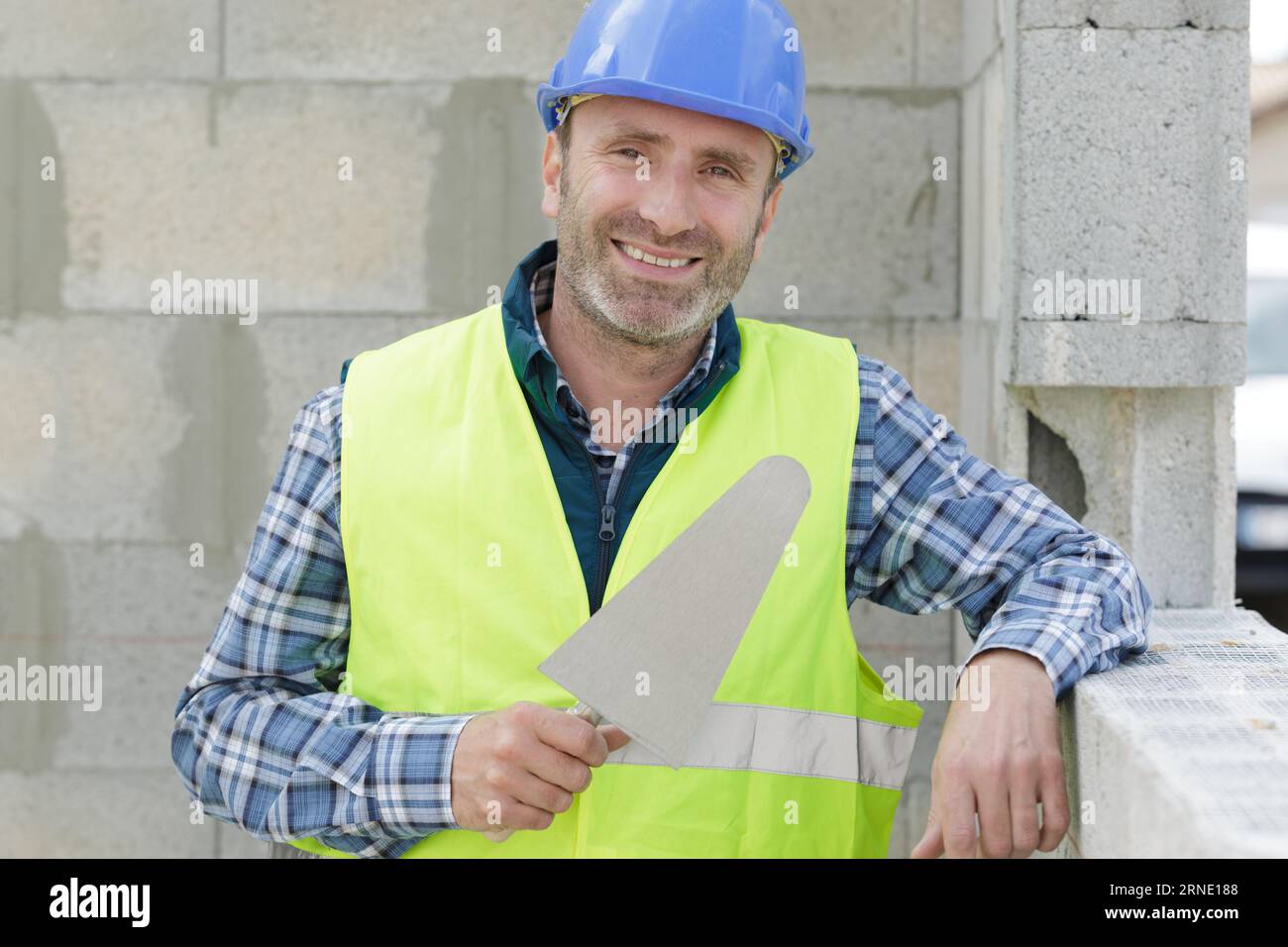 a senior builder with spatula Stock Photo - Alamy