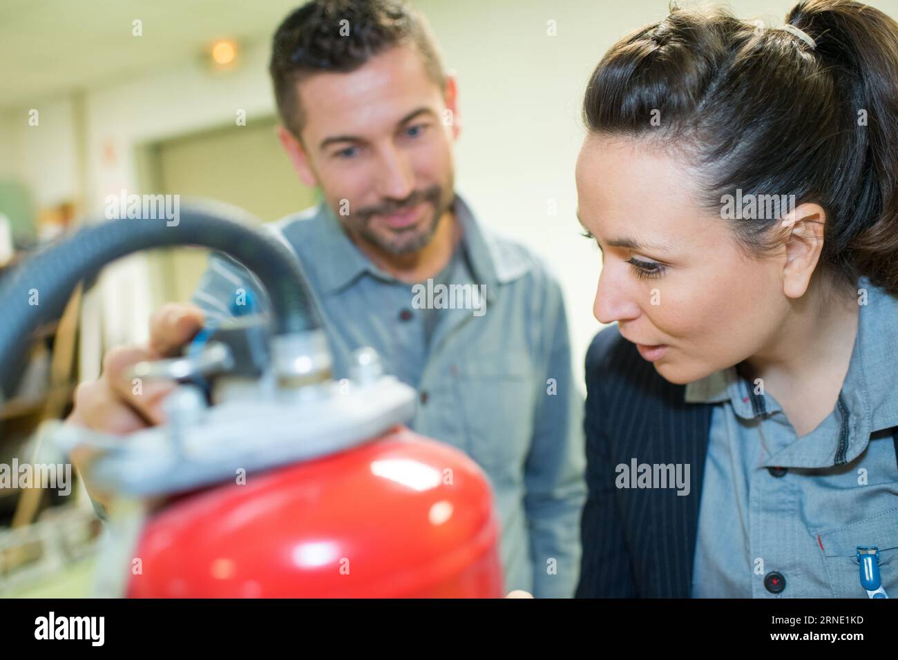 woman and man fixing an object Stock Photo - Alamy