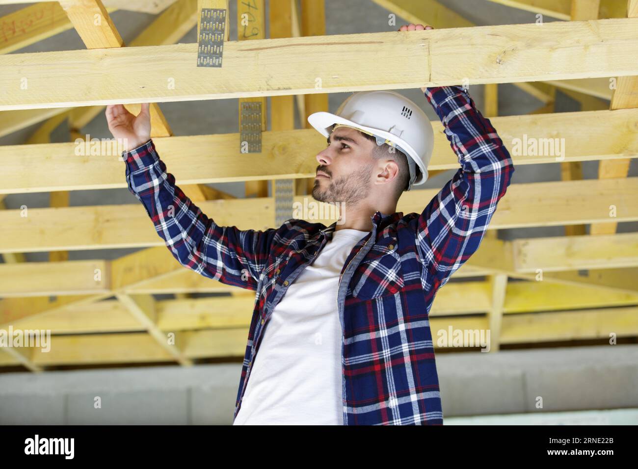 worker roofer builder working on roof structure on construction site ...