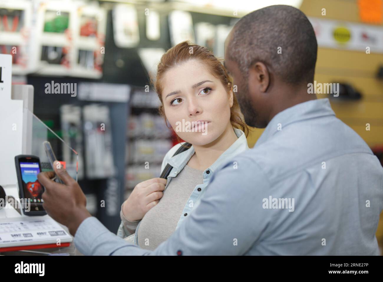 Salesman assisting customer smartphone hi-res stock photography and ...