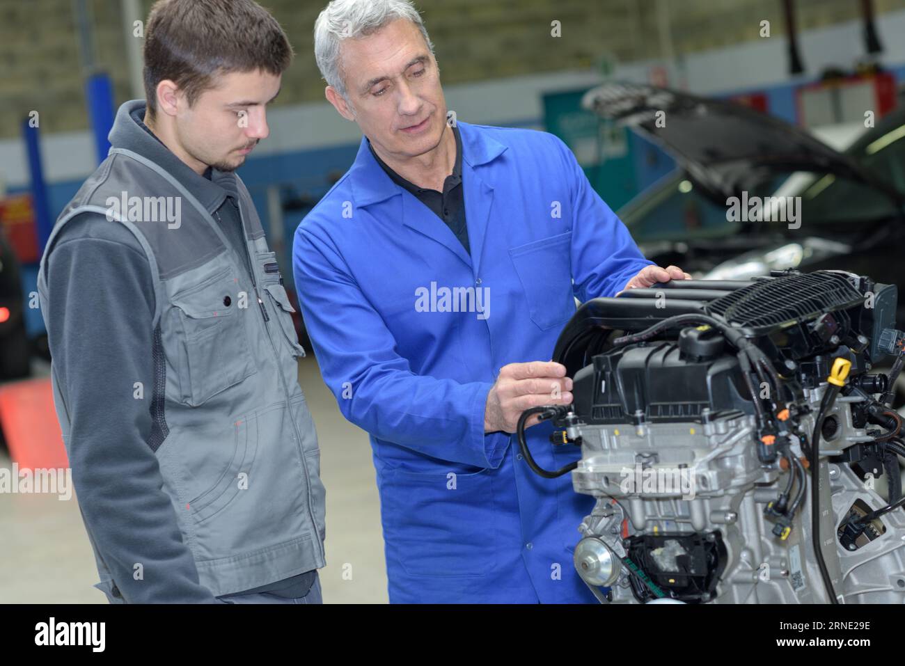 student with instructor repairing a car during apprenticeship Stock ...