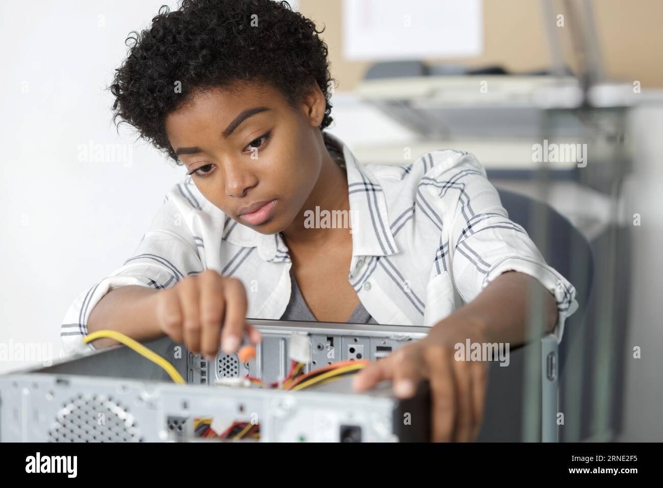 young woman fix pc components in classroom Stock Photo - Alamy