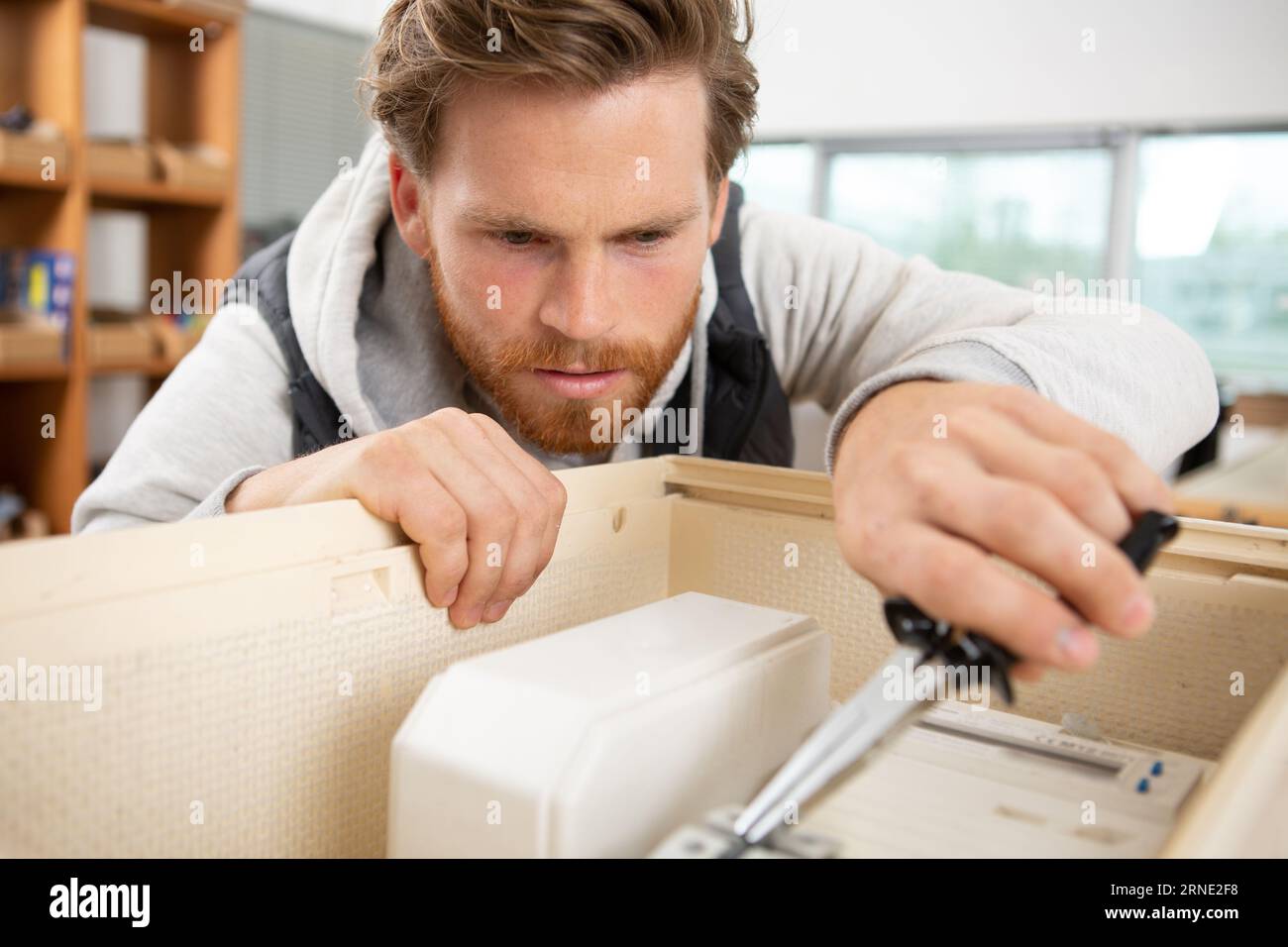 a young man fixing box Stock Photo - Alamy