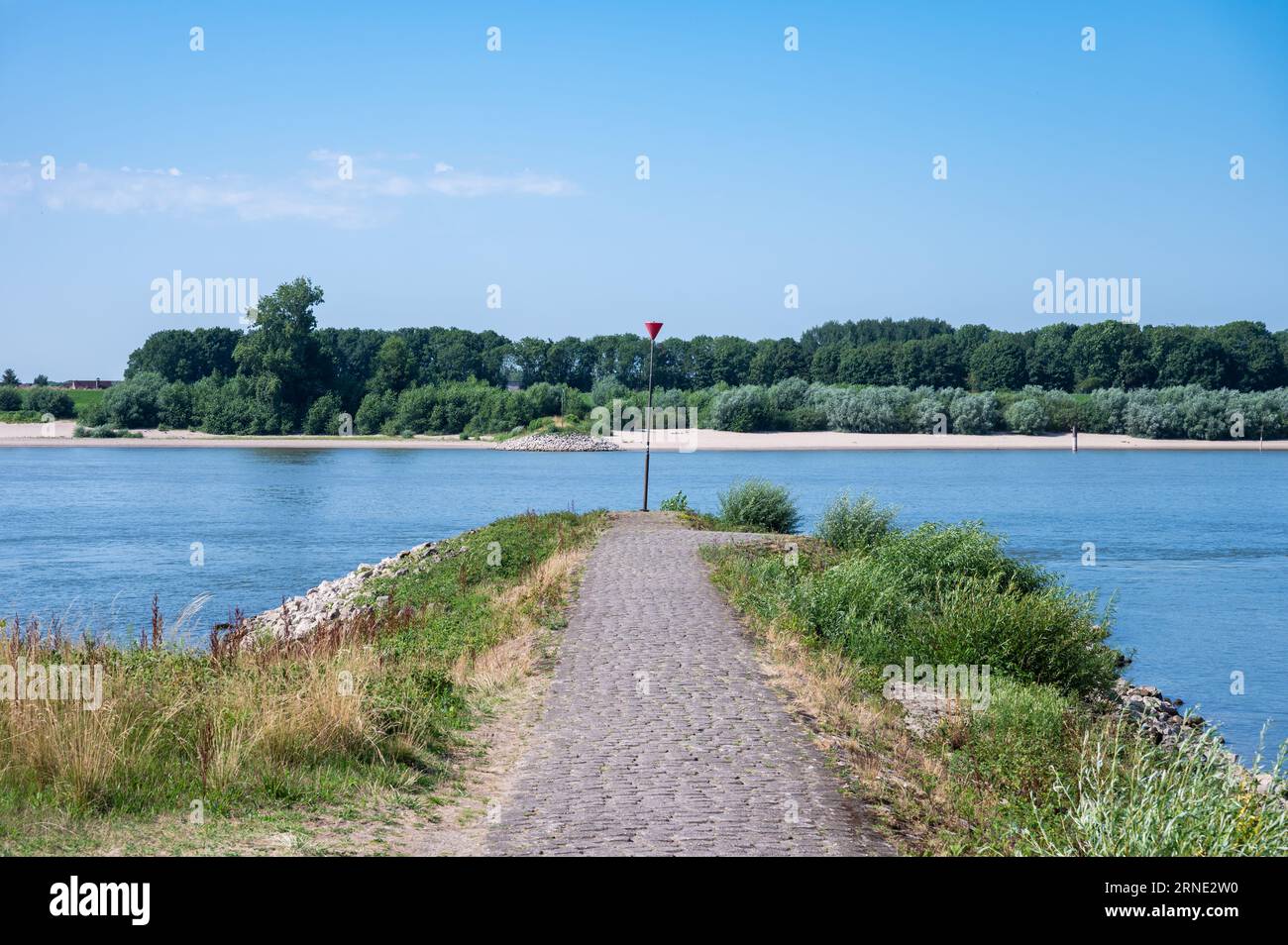 Stone jetty towerds the ferry stop crossing the river Waal, Millingen ...