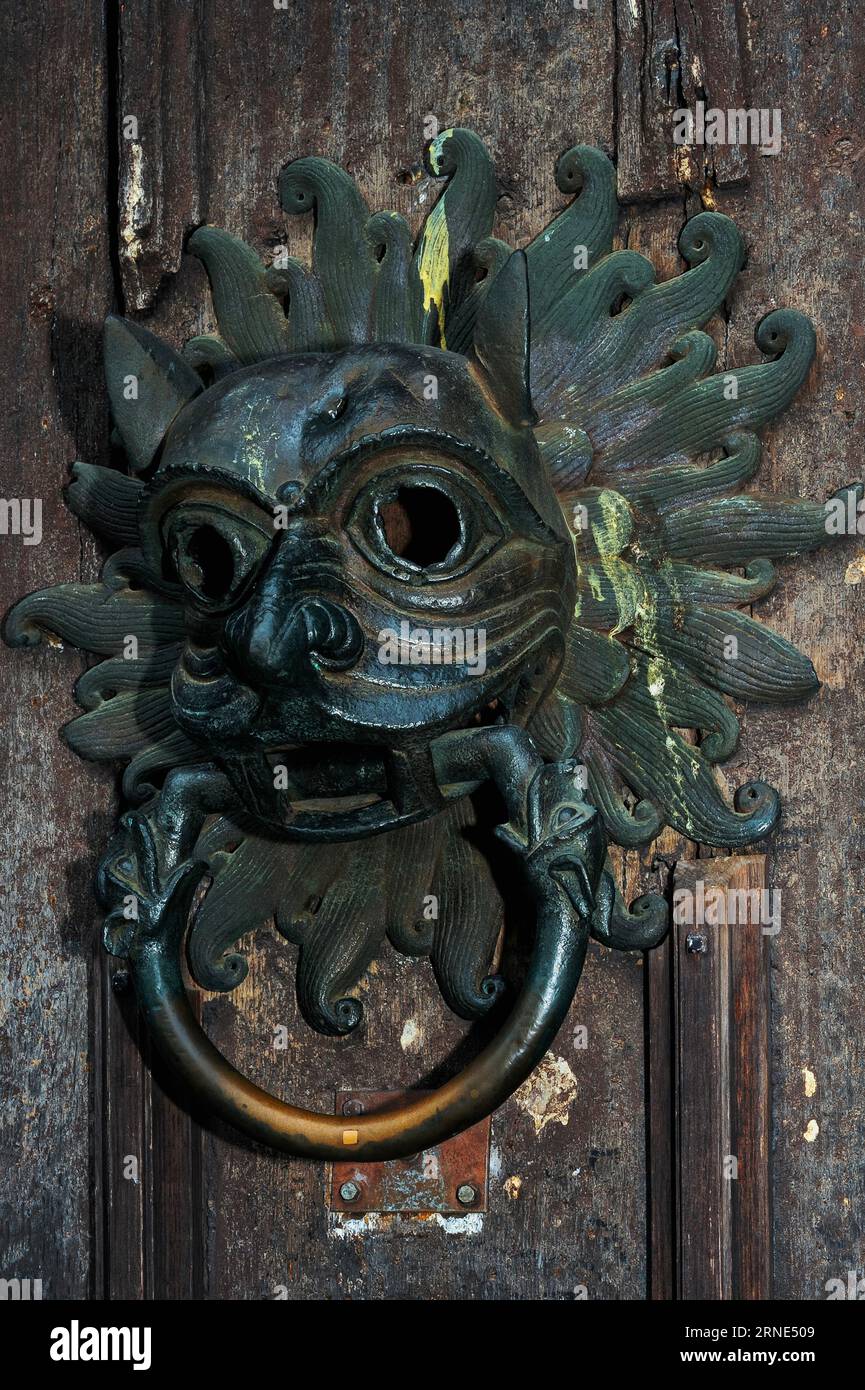 Bronze sanctuary knocker on north door of Durham Cathedral. A lion, its ...