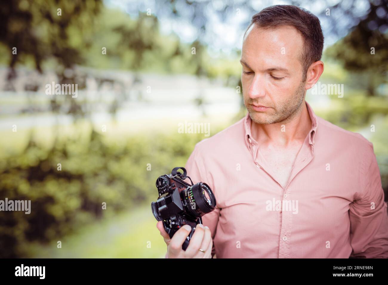 photographer with retro camera look at his vintage machine with old ...