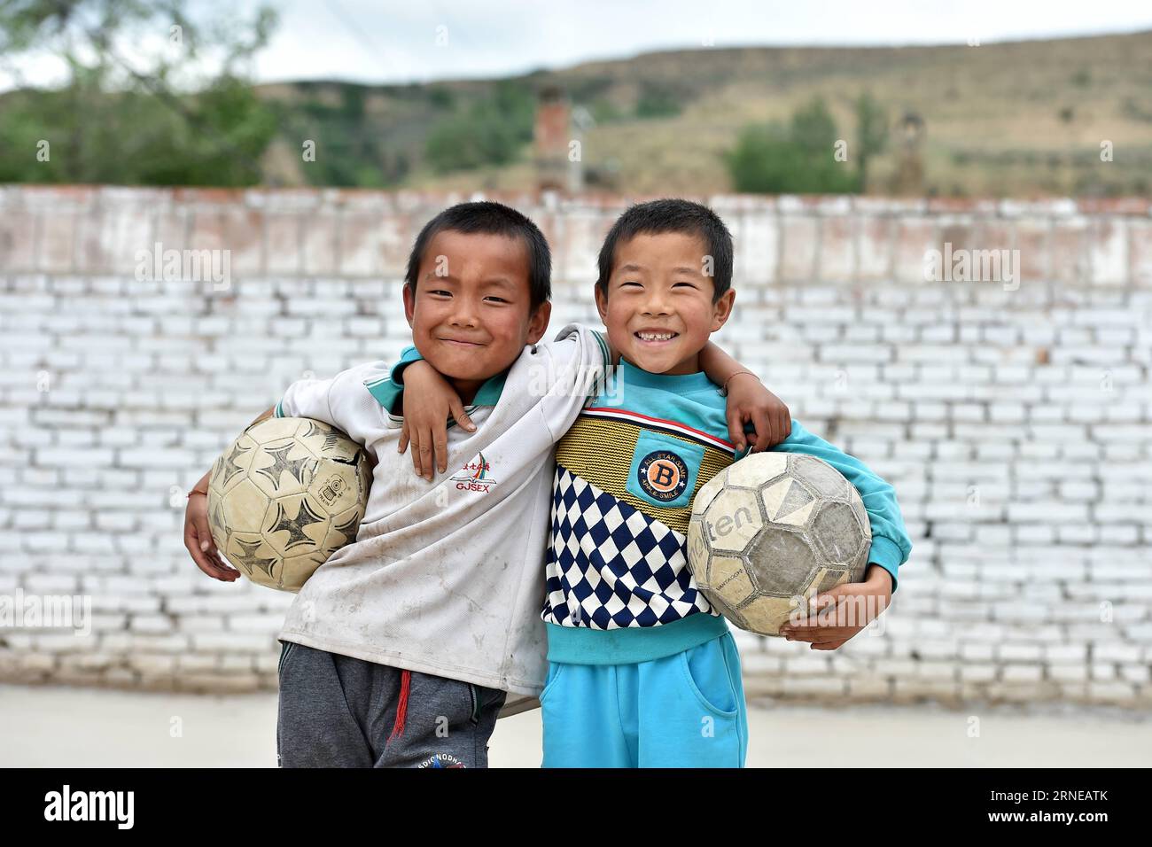 Photo taken on June 14, 2016 shows eight-year-old Liu Guobin (R) and ...