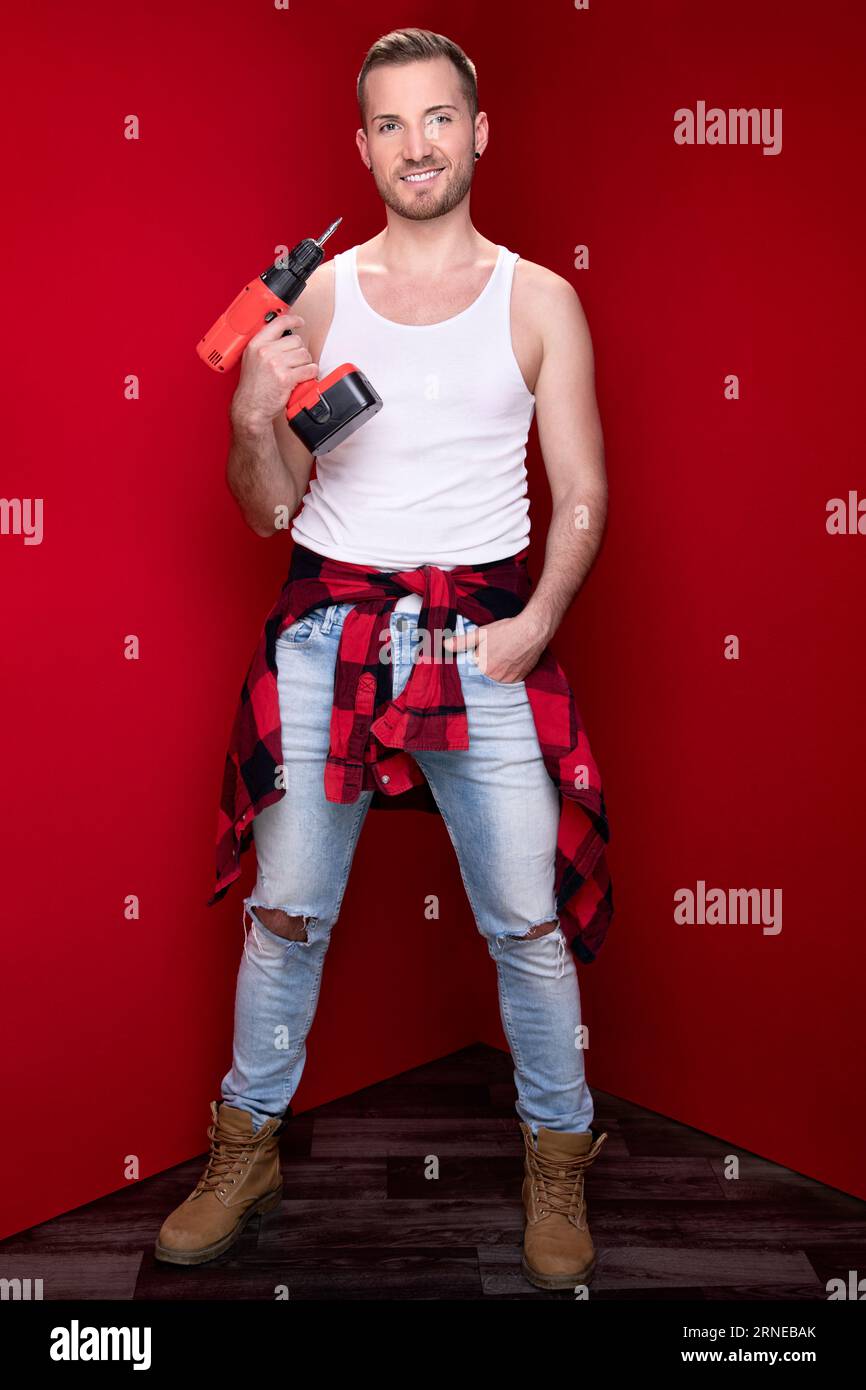 diy handmade addicted worker in white shirt holding red drilling ...