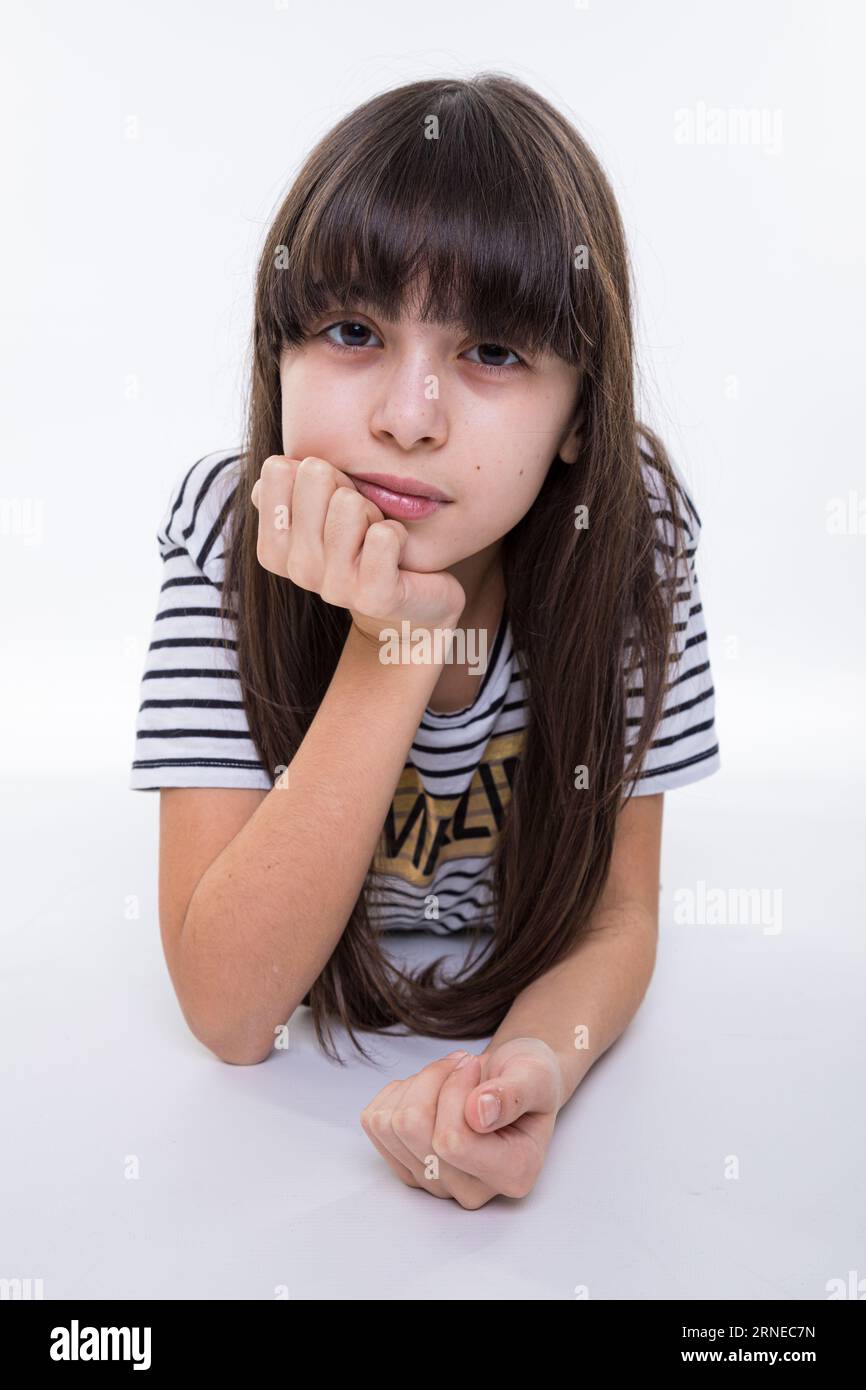 annoyed and bored teen girl lie on floor and look with serious ...