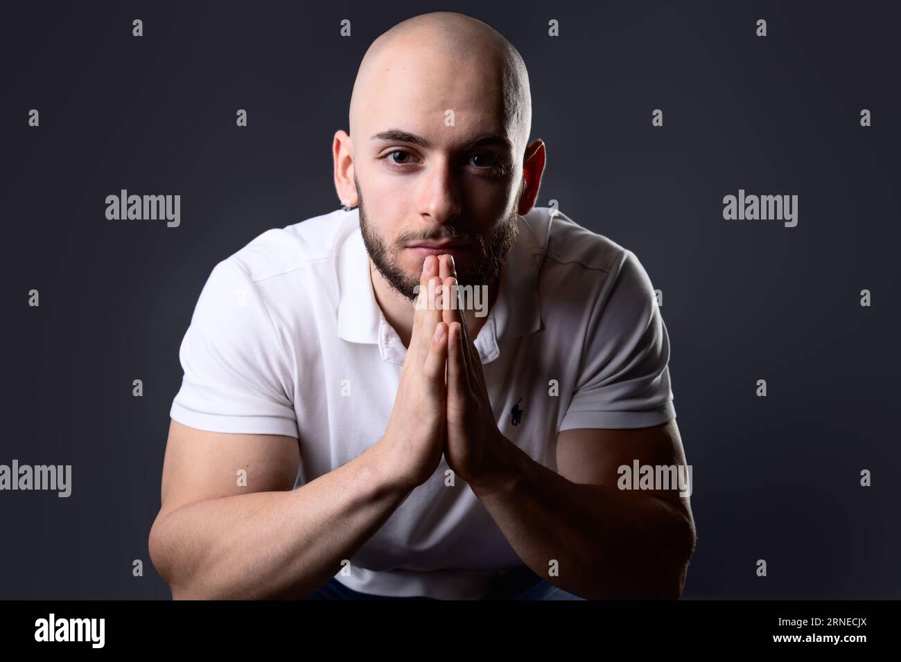 turkish man fold hands in front of his face like he is praying while ...
