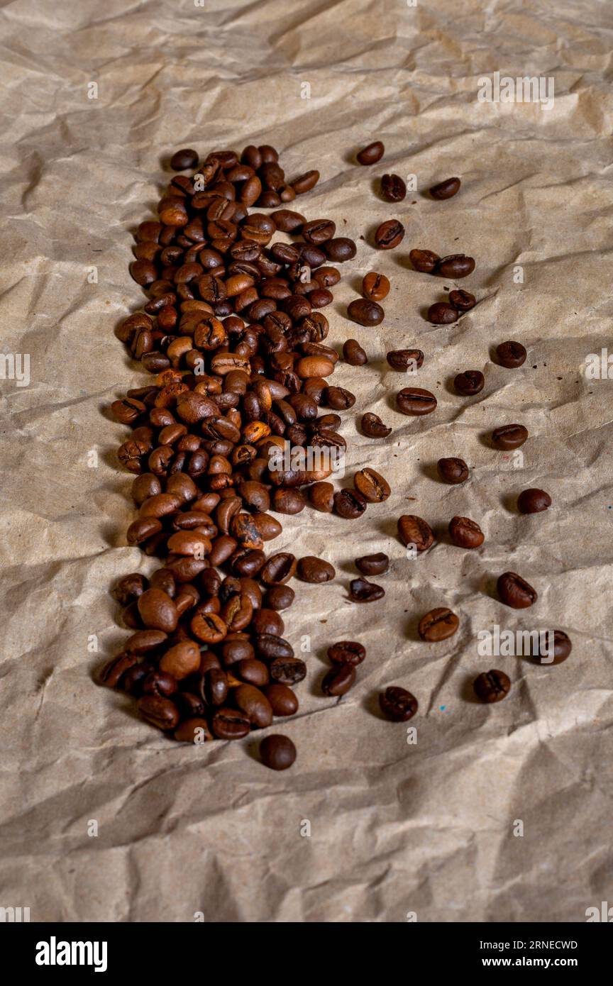 Roasted coffee beans on a paper background Stock Photo - Alamy