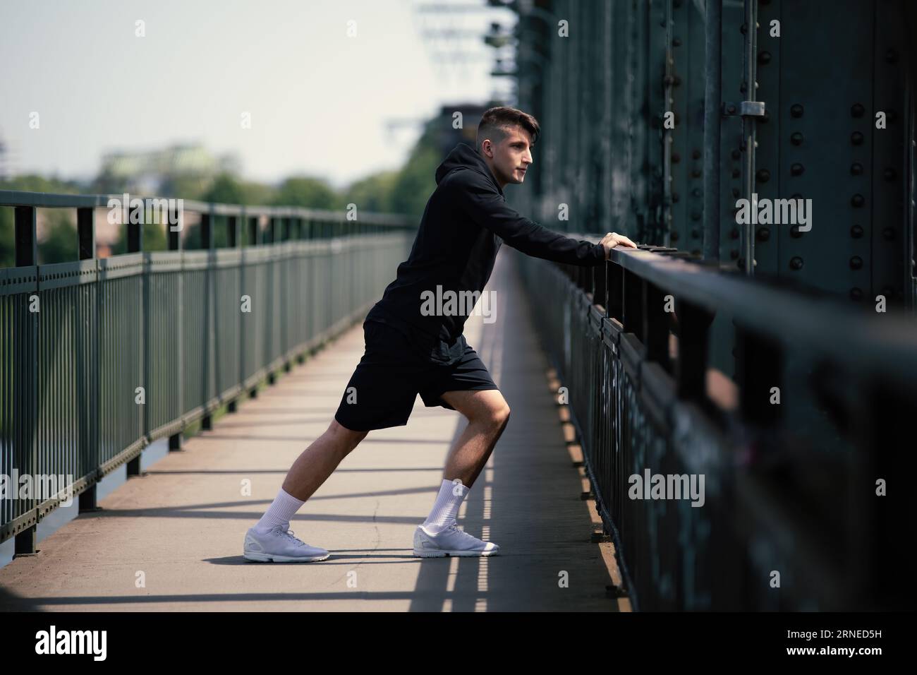 sportive runner stretch tendons and ligaments in legs to warm up the ...