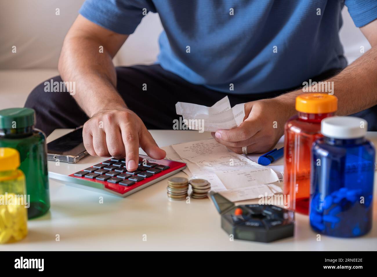 Male calculating costs of medicine while holding receipts Stock Photo ...