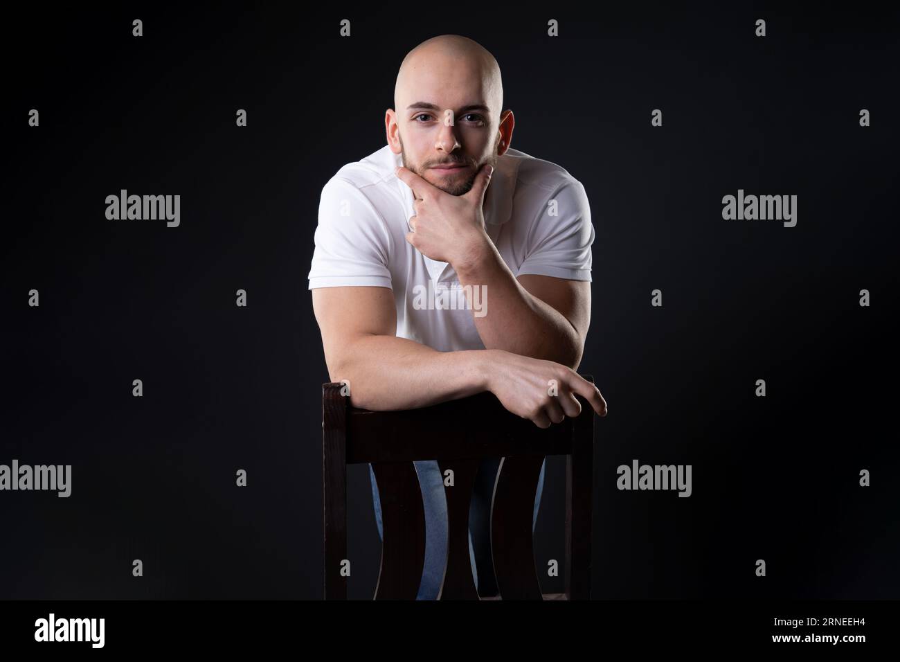 bald man with fingers on chin lean on chair lost in deep thought with ...