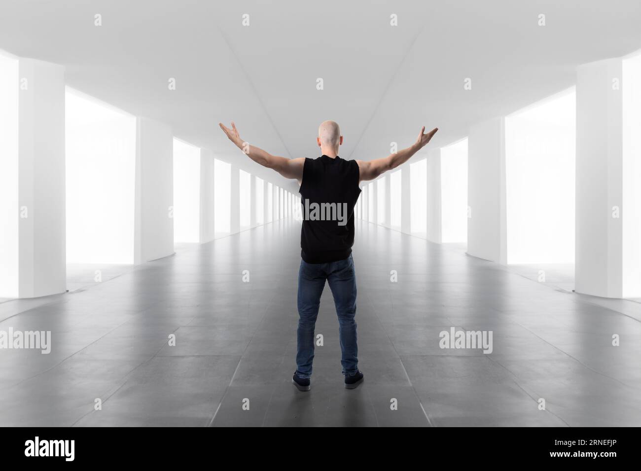 Confident Young Man Standing in a Spacious White Endless Room with Arms ...