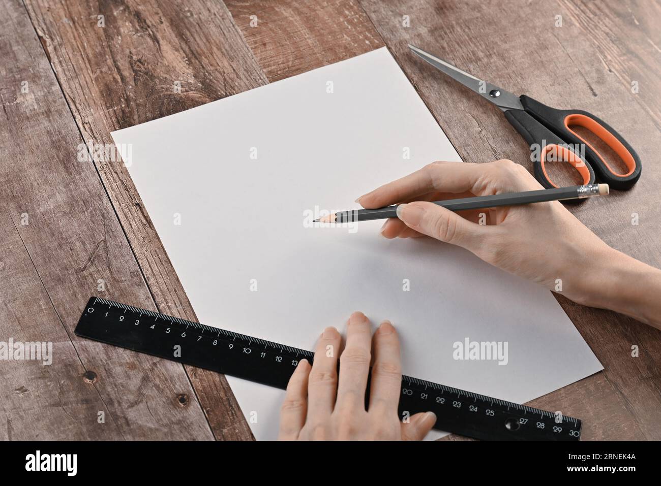 hands of an elderly woman fold origami paper. Creating an origami paper ...
