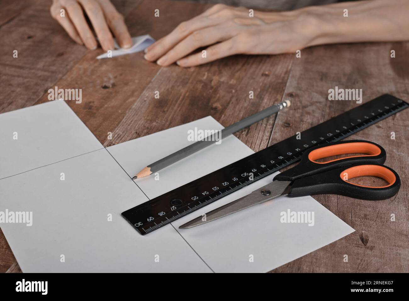 hands of an elderly woman fold origami paper. Creating an origami paper ...