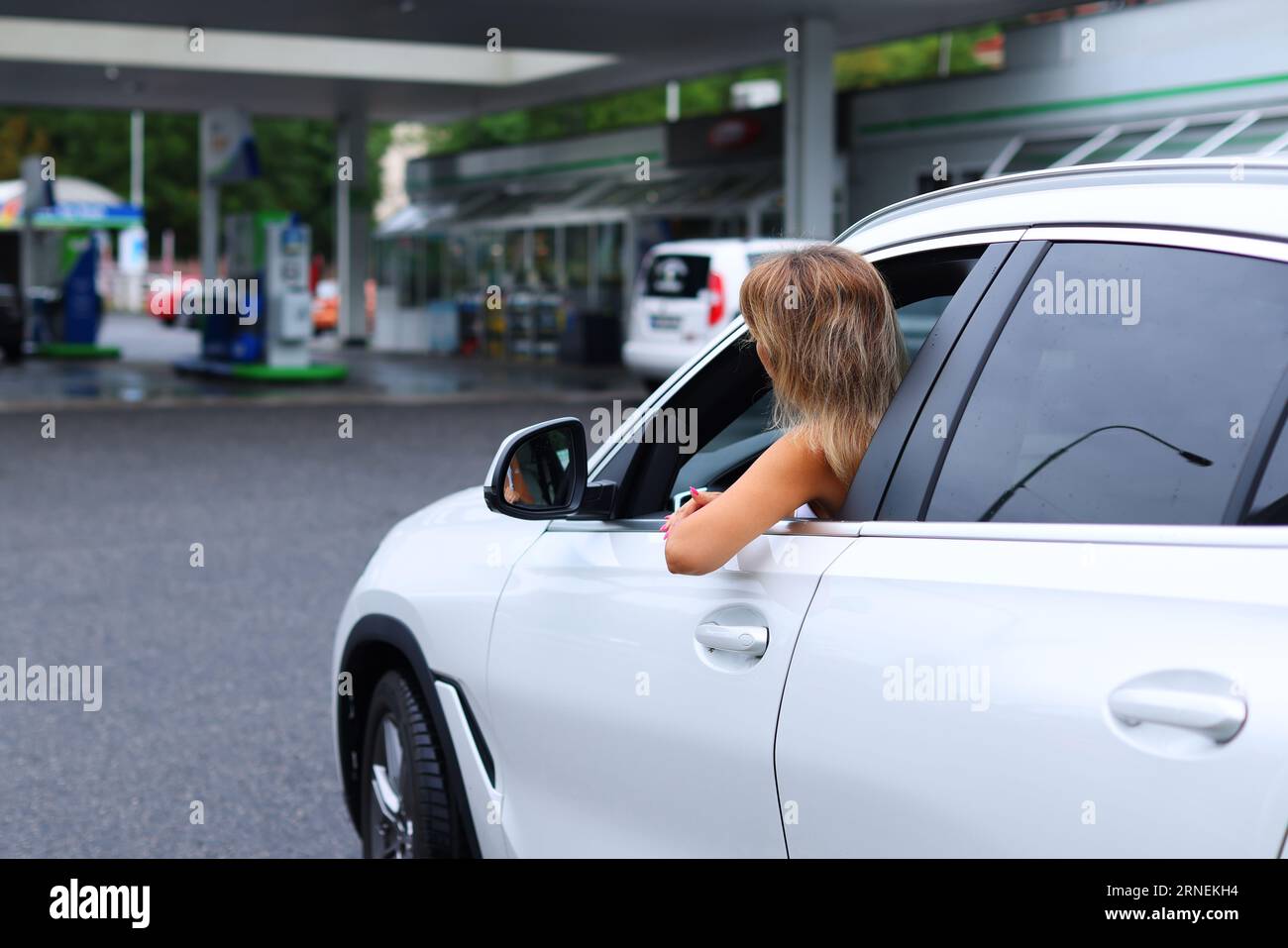 Woman At Gas Station Waiting Inside A Car Stock Photo Alamy