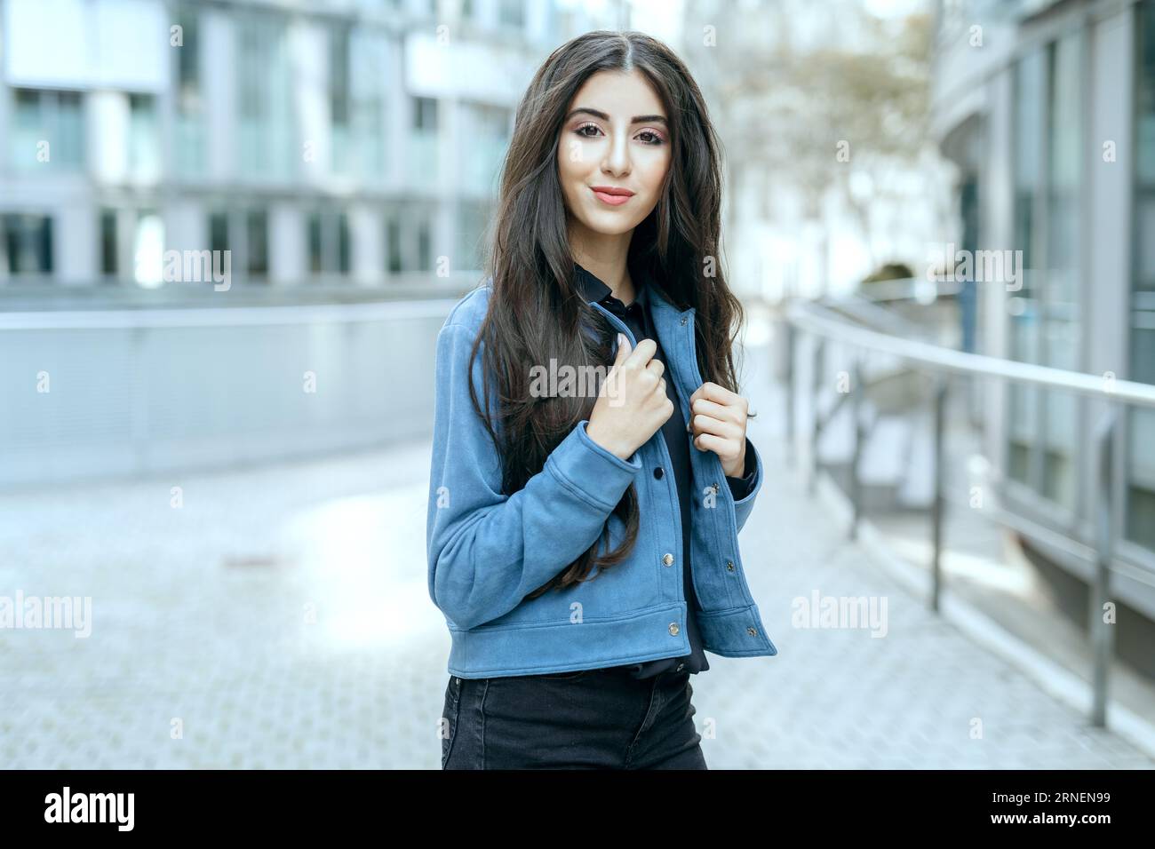 teenage girl posing in city while look neutral into camera with make up ...