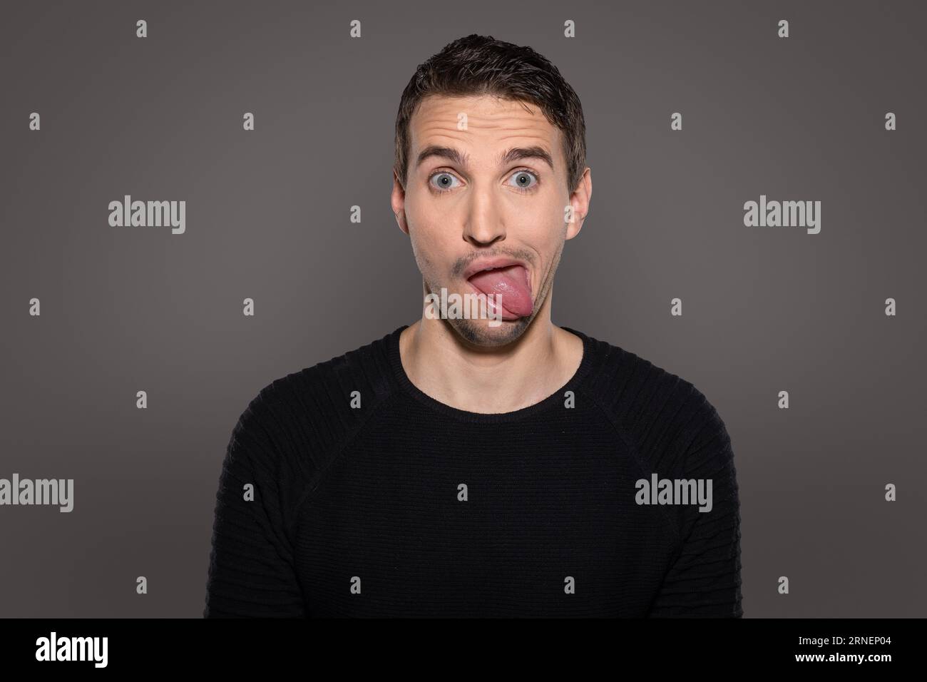 crazy smiling man having fun while show his tongue and having a ...