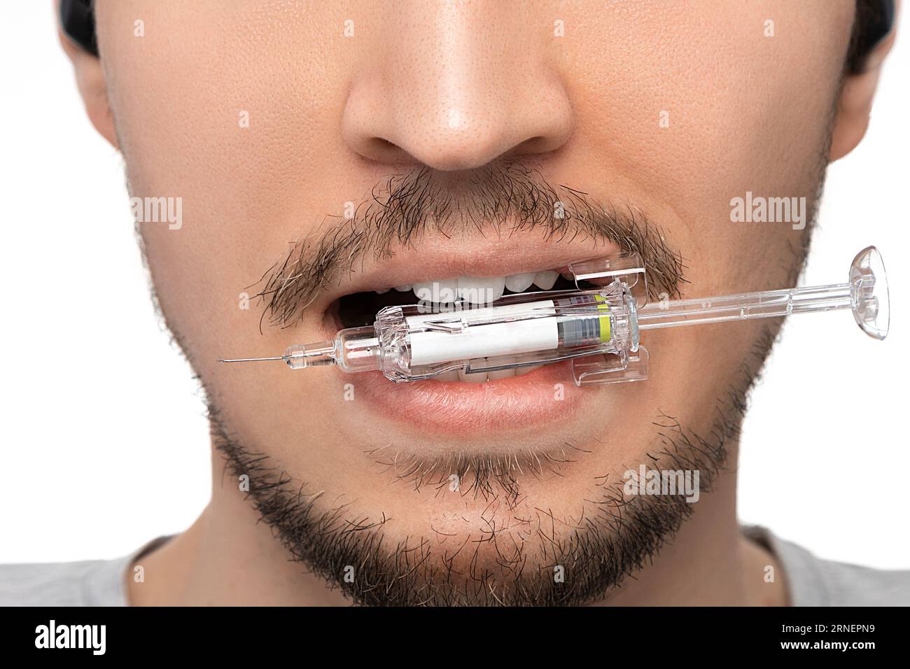 male tooth bite on syringe with vaccine of coronavirus Stock Photo - Alamy