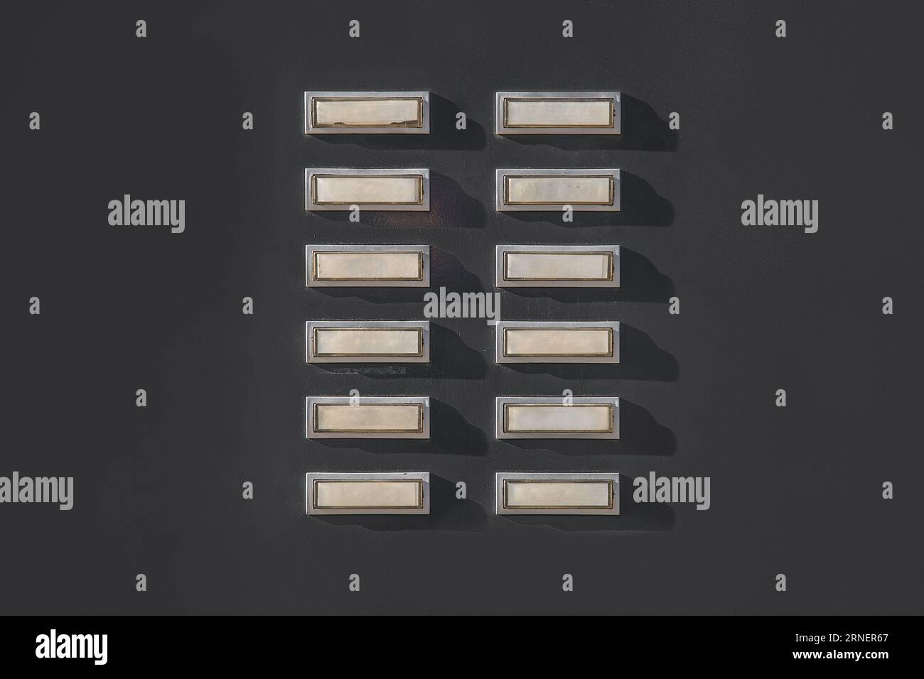 empty name tags of multiple door bell buttons on front of minimalistic ...