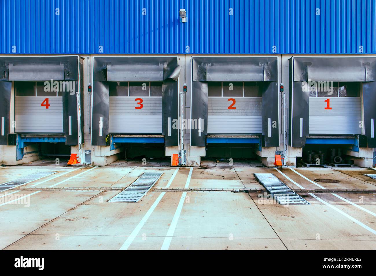 Loading ramps with numbers on closed shutter doors and empty space in ...