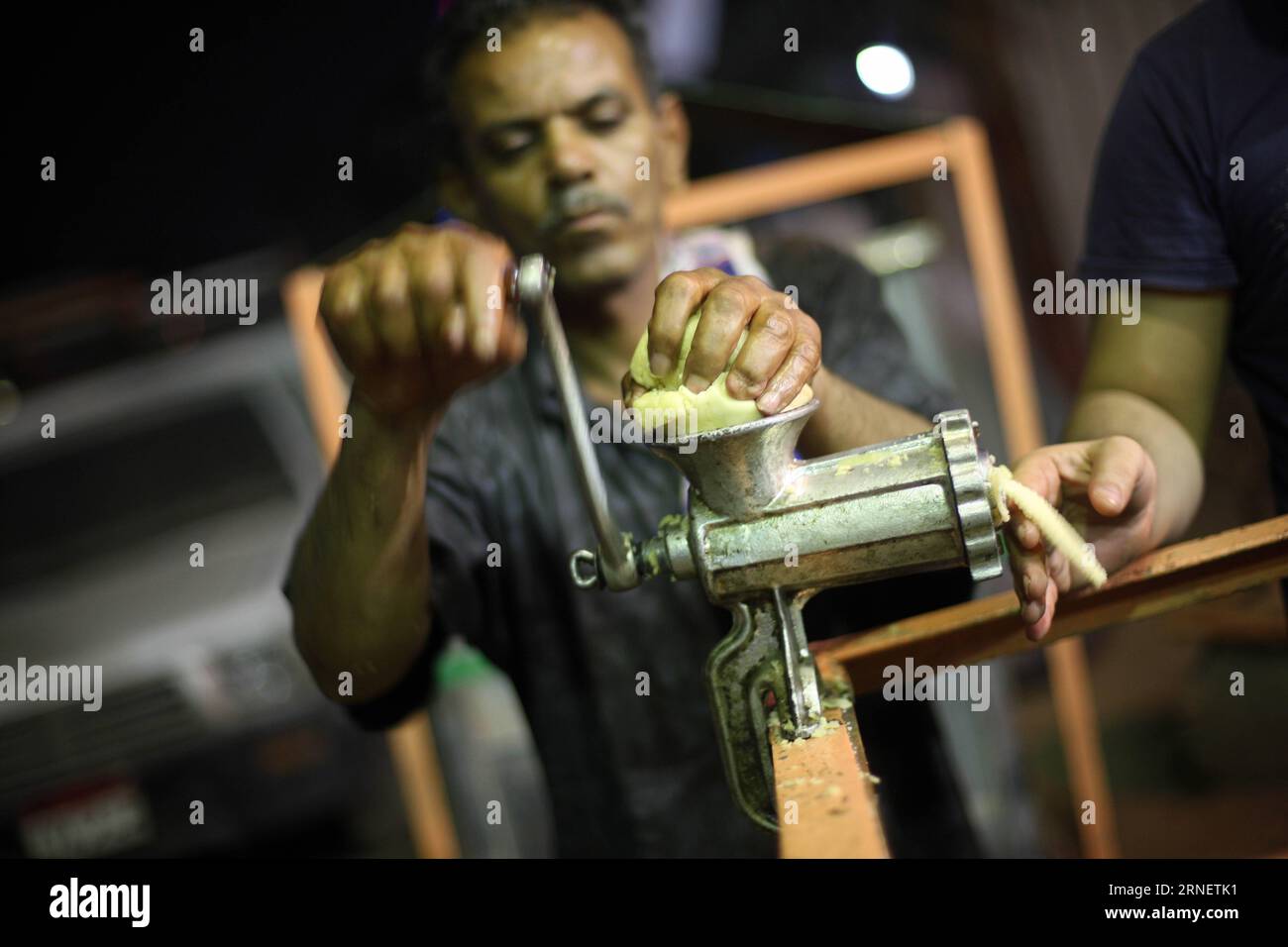 MANSOURA, July 3, 2016 -- An Egyptian baker prepares Kahk , a ...