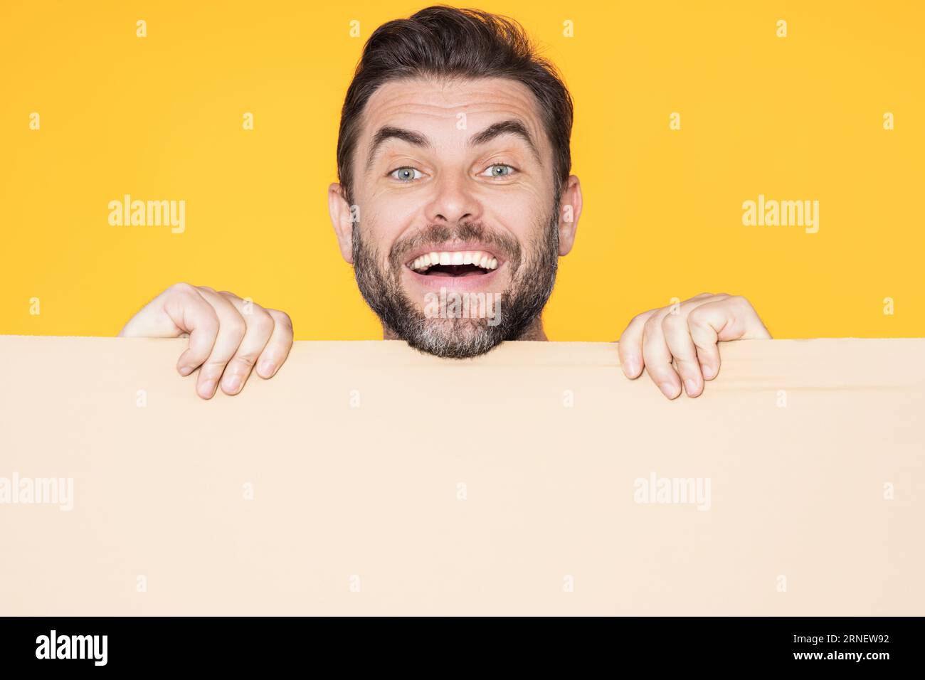 Happy man holds the sign, blank card. Placard ready for your product ...