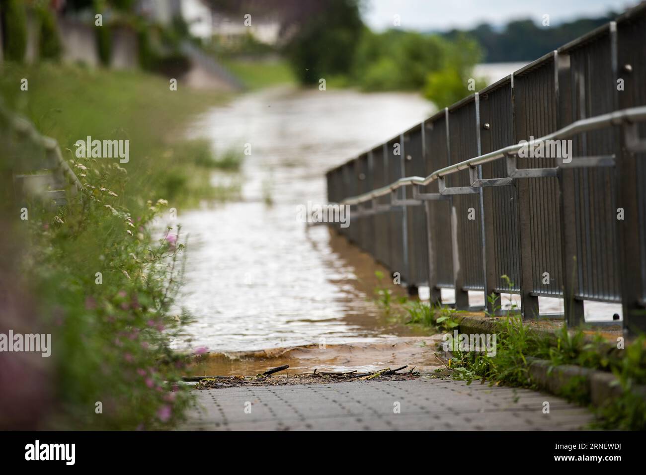flood at sidewalk shows high water raising by heavy rainfalls making ...