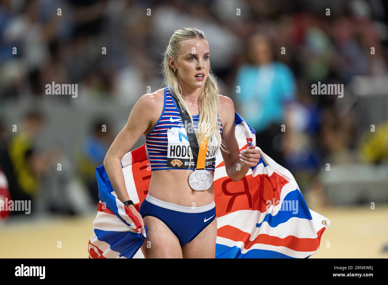 Keely Hodgkinson celebrating her medal with her country's flag in the ...