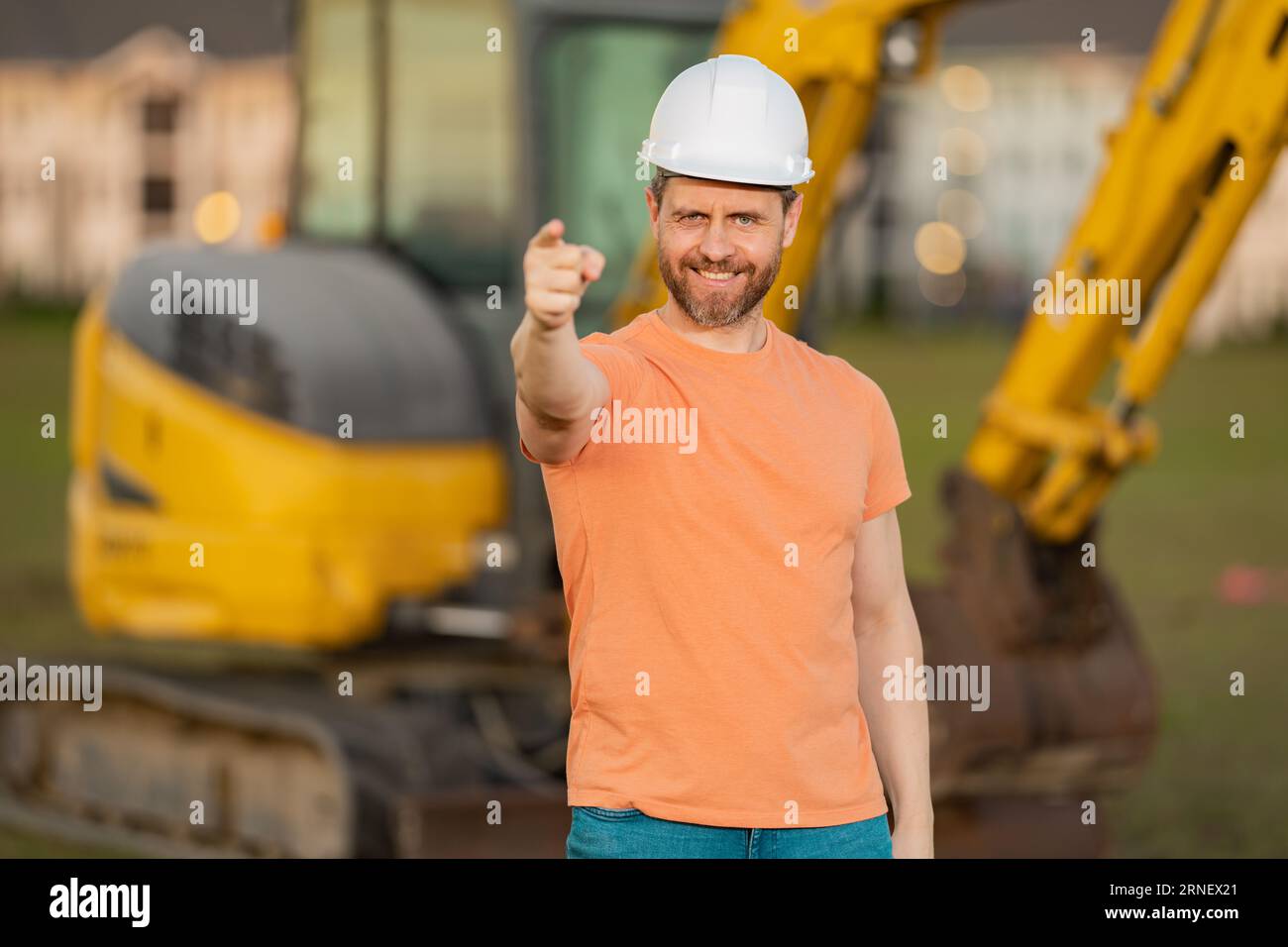 Builder with excavator for construction at the construction site ...