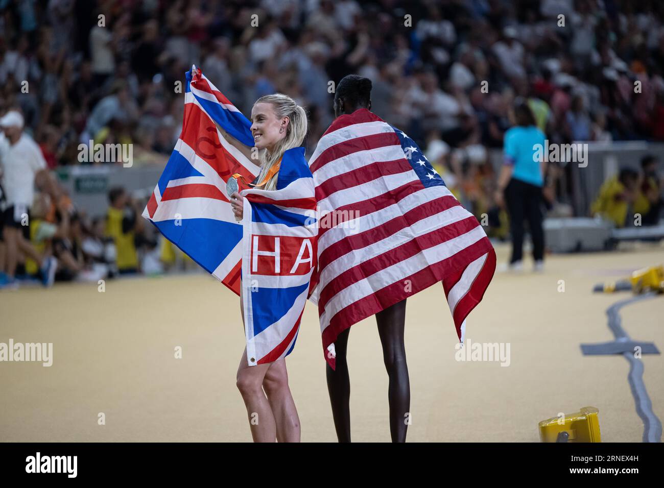 Keely Hodgkinson celebrating her medal with her country's flag in the ...
