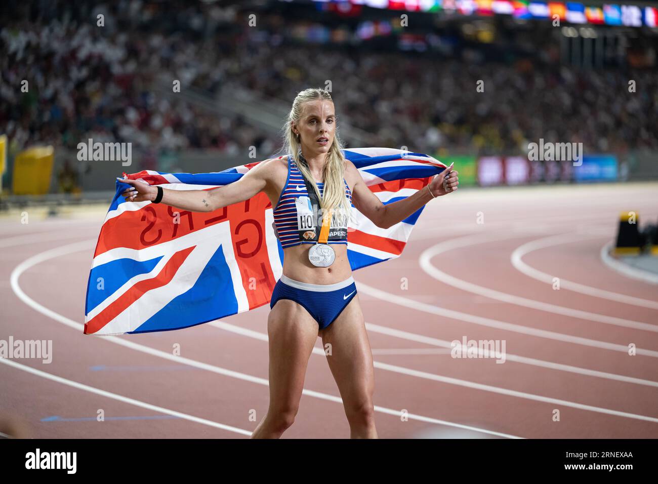 Keely Hodgkinson celebrating her medal with her country's flag in the ...