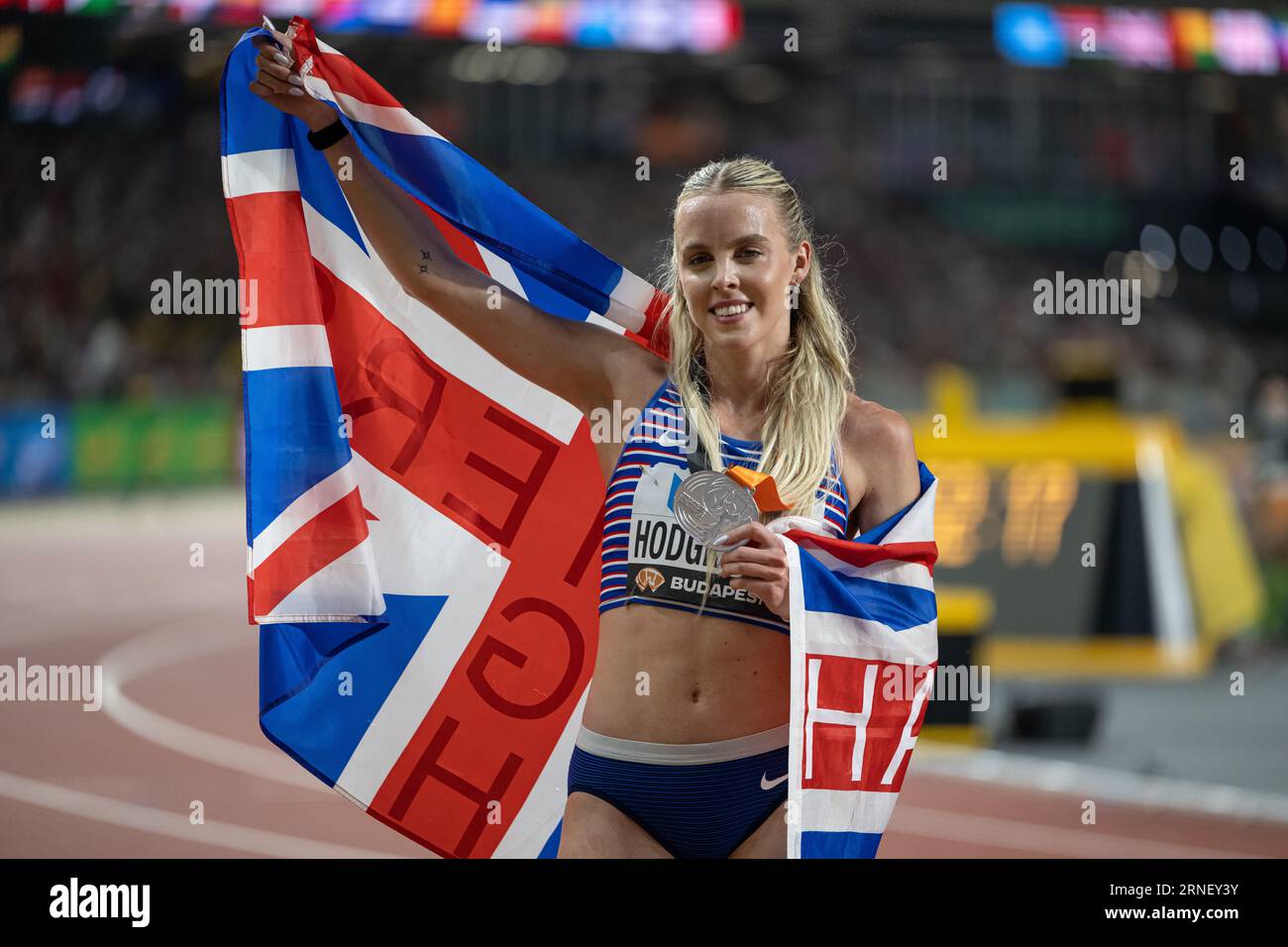 Keely Hodgkinson celebrating her medal with her country's flag in the ...