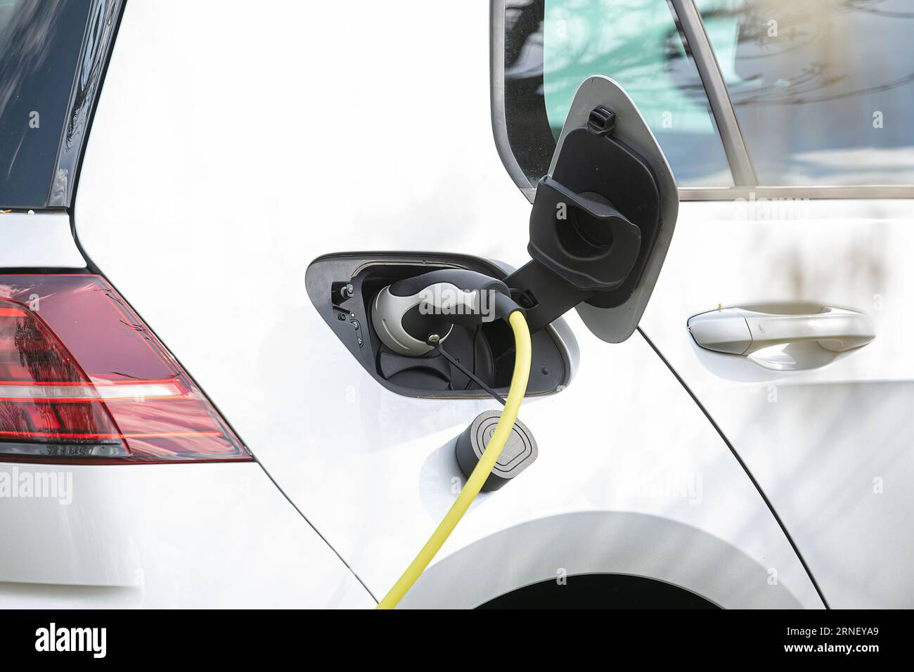 plug in adapter in car charge battery of electric car next to a ...