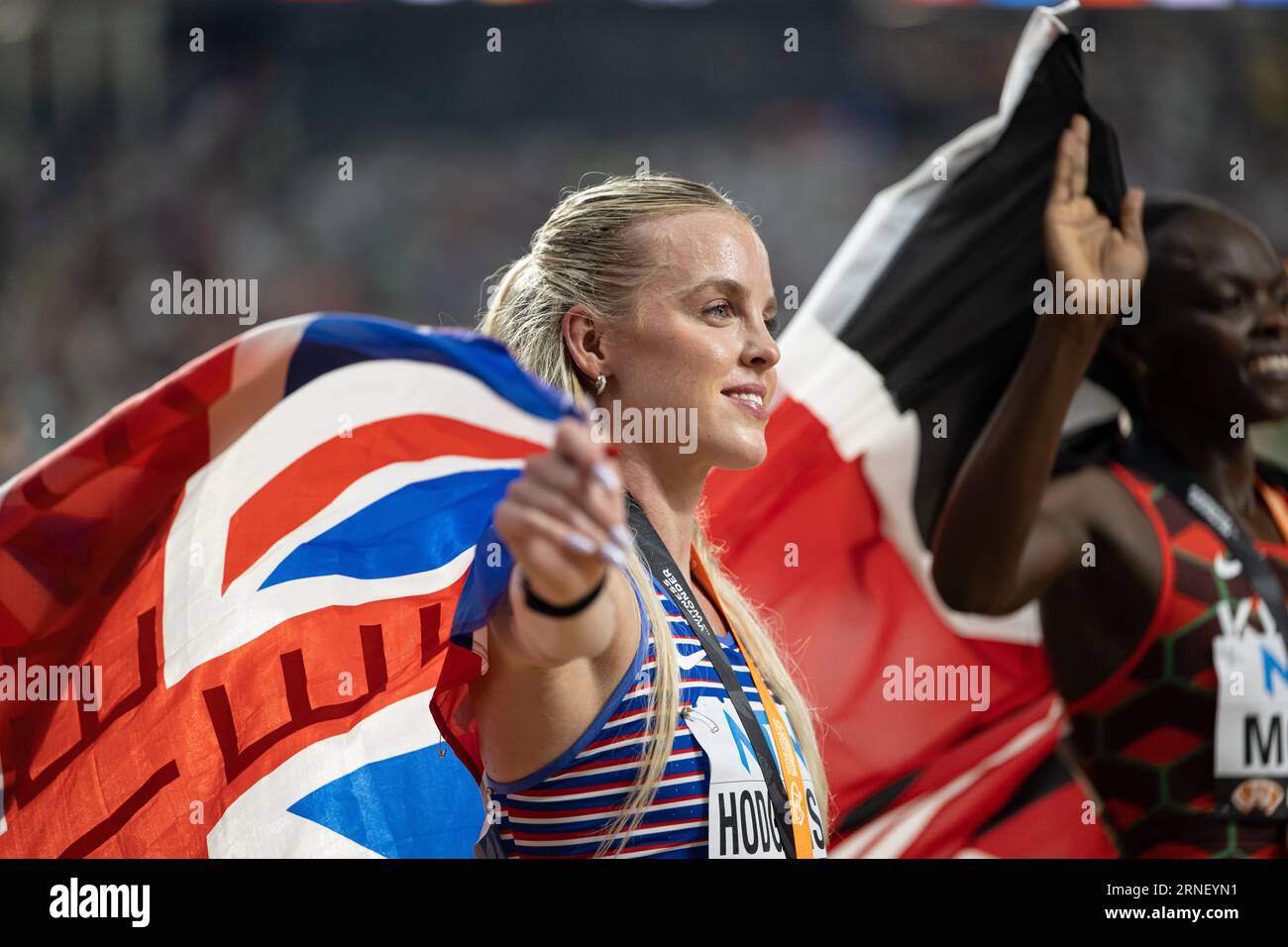 Keely Hodgkinson celebrating her medal with her country's flag in the ...