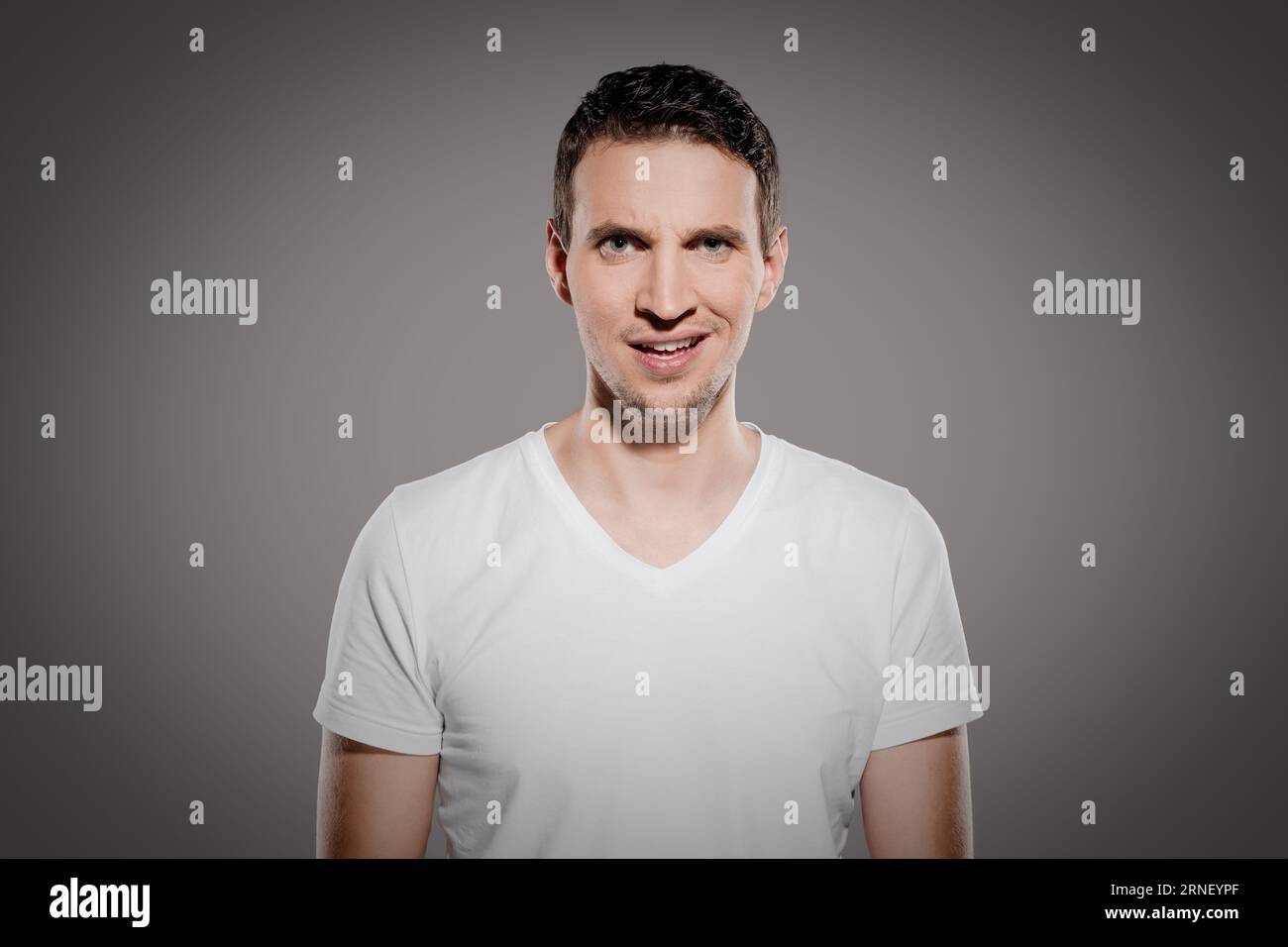 stupid and mindless face expression of man while look at camera and ...