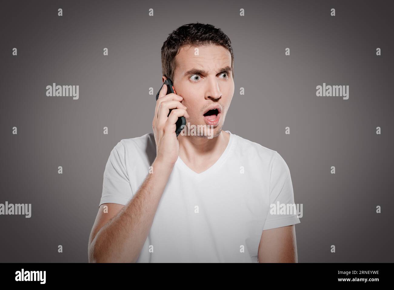 outraged face expression of man on the phone while calling and look to ...