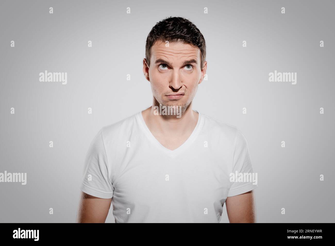 bored and annoyed face expression of man while look at camera and show ...