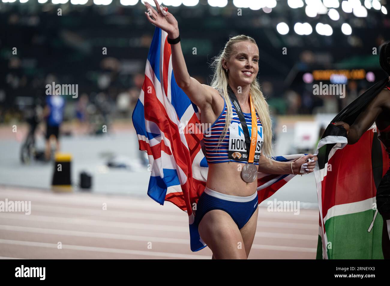 Keely Hodgkinson celebrating her medal with her country's flag in the ...