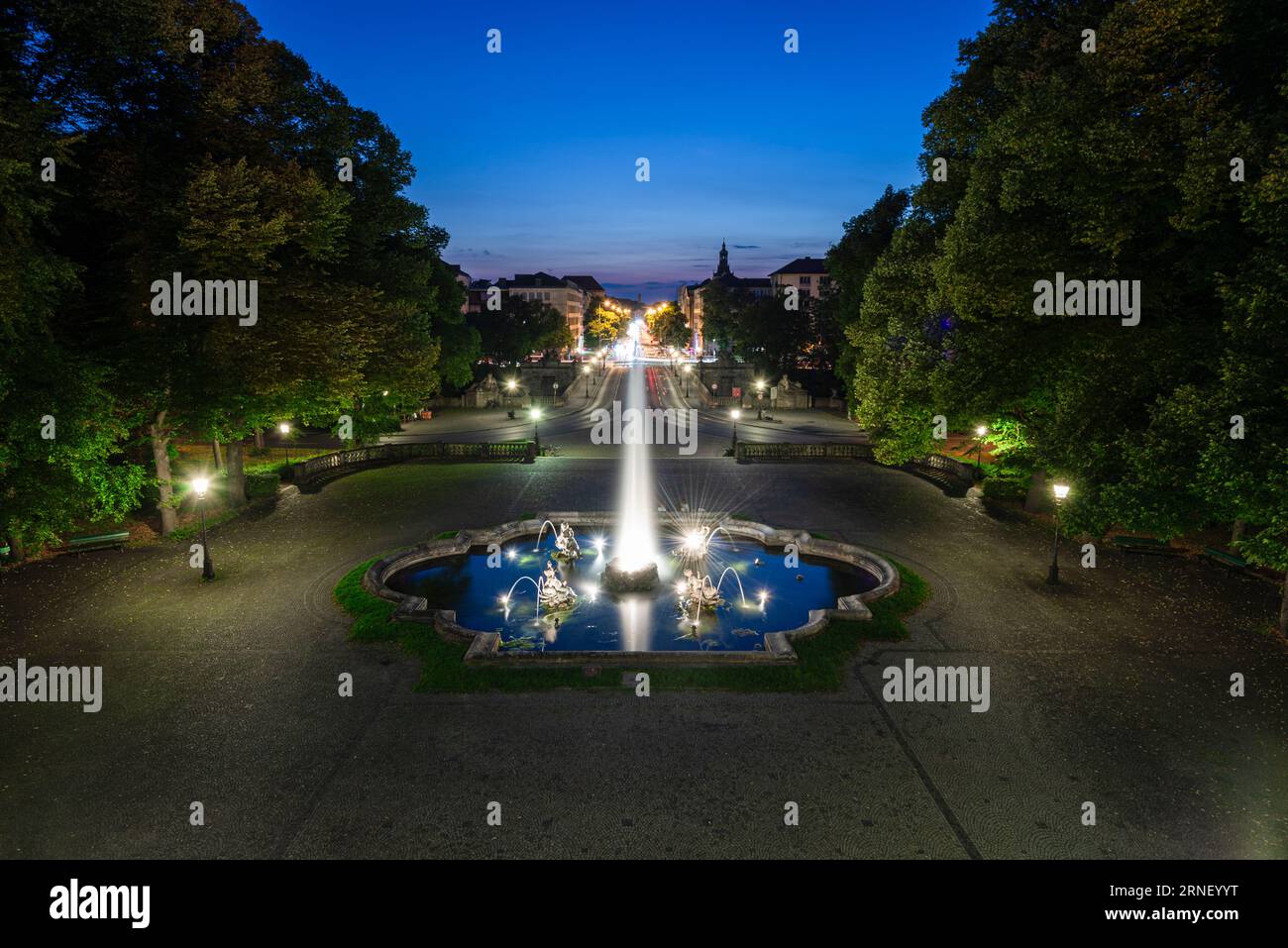 Illuminated fountain with water jets in front of the Luitpold bridge ...