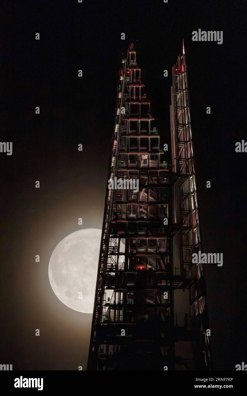 Blue super moon rises over The Shard in London. A ‘blue’ moon refers to ...