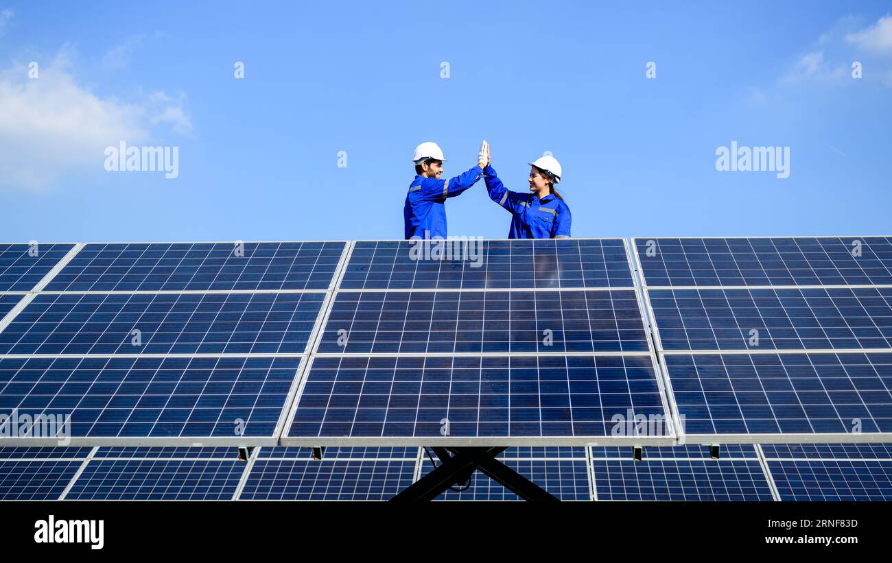 Technicians workers installing solar panels at solar cell farm Stock ...