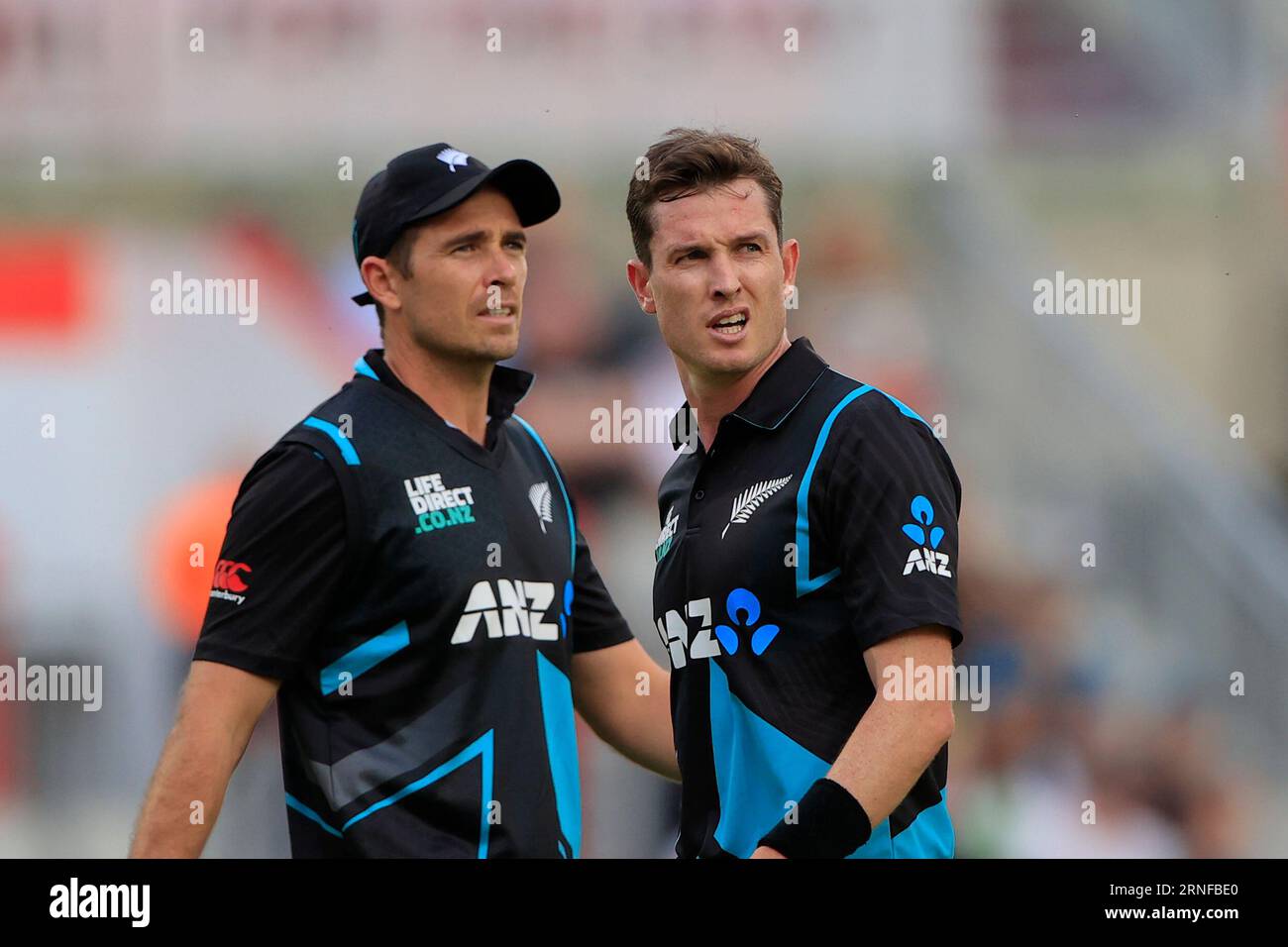 Adam Milne #20 of New Zealand and Tim Southee #38 of New Zealand have a ...