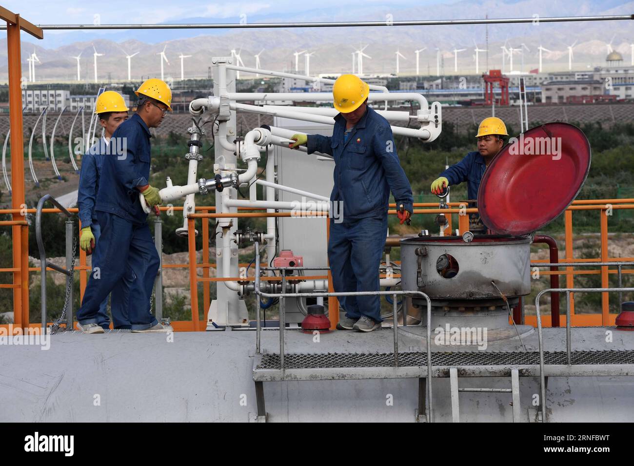 Technicians work on the filling line for liquefied petroleum gas (LPG ...