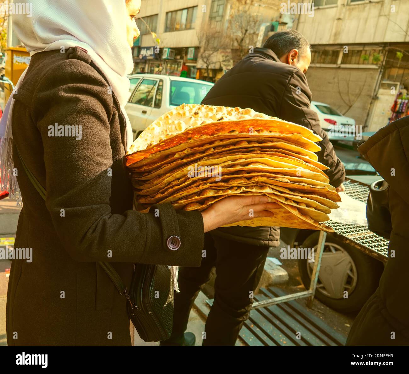 Tehran, Iran - December 19, 2022: Stack of flatbread, tortillas in woman's hands Stock Photo - Alamy