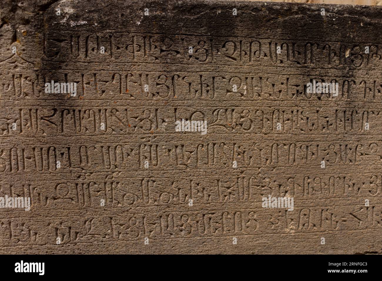 An ancient Armenian stone tablet with a weathered and faded inscription ...