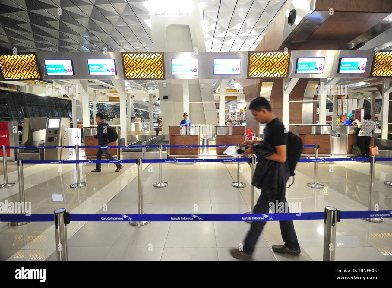 (160809) -- JAKARTA, Aug. 9, 2016 -- A man walks in front of check-in ...
